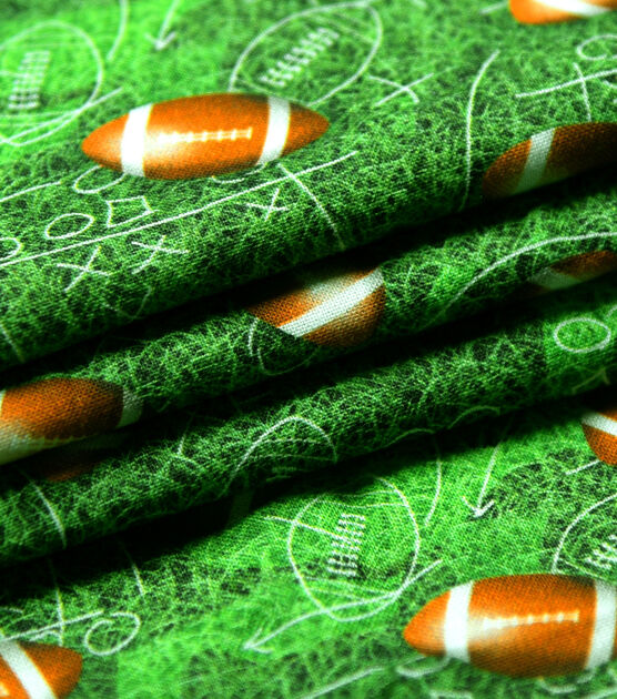 Footballs On Green Novelty Cotton Fabric Joann